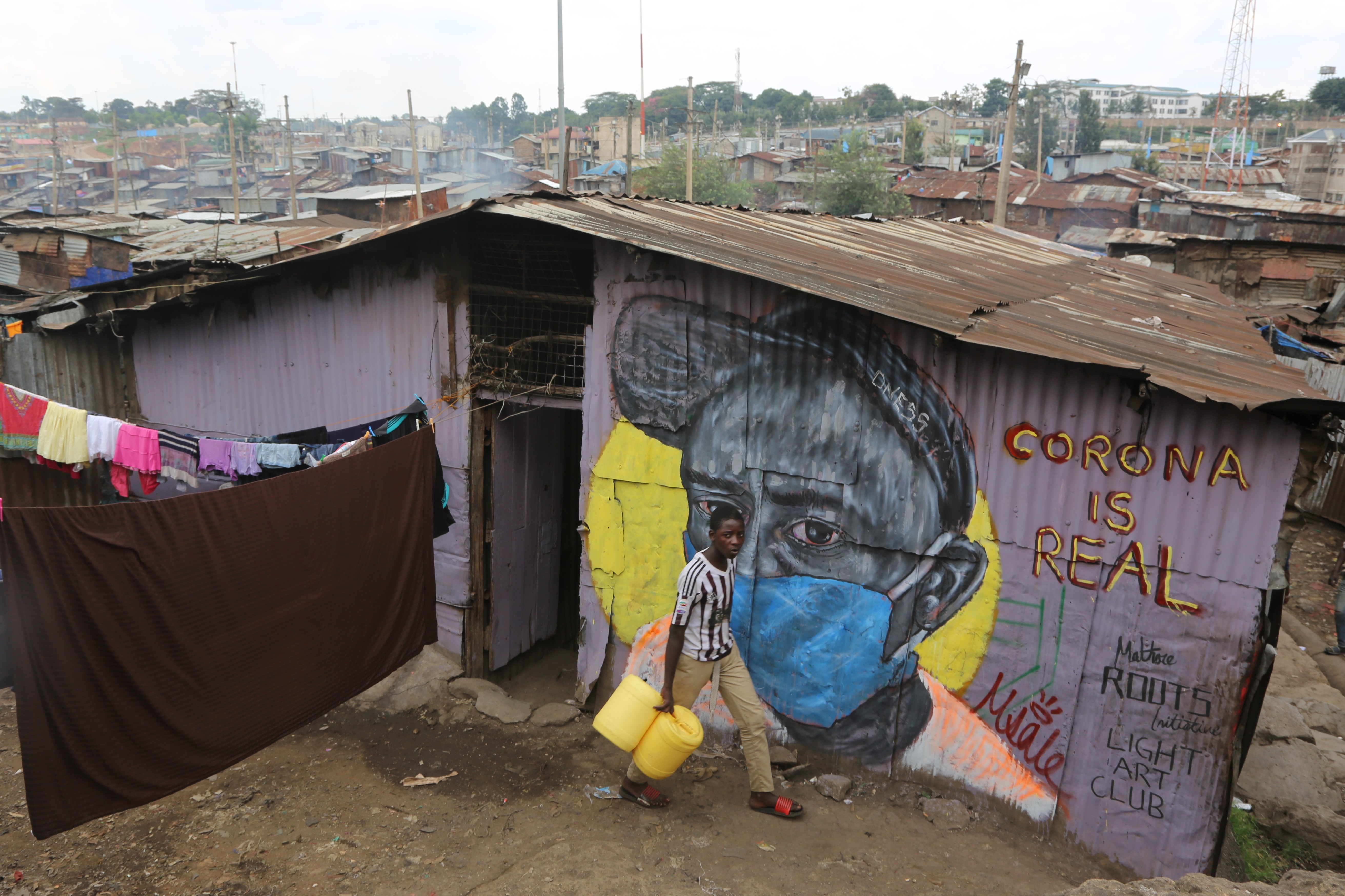 Youth in Nairobi slum use murals to educate the community about COVID ...